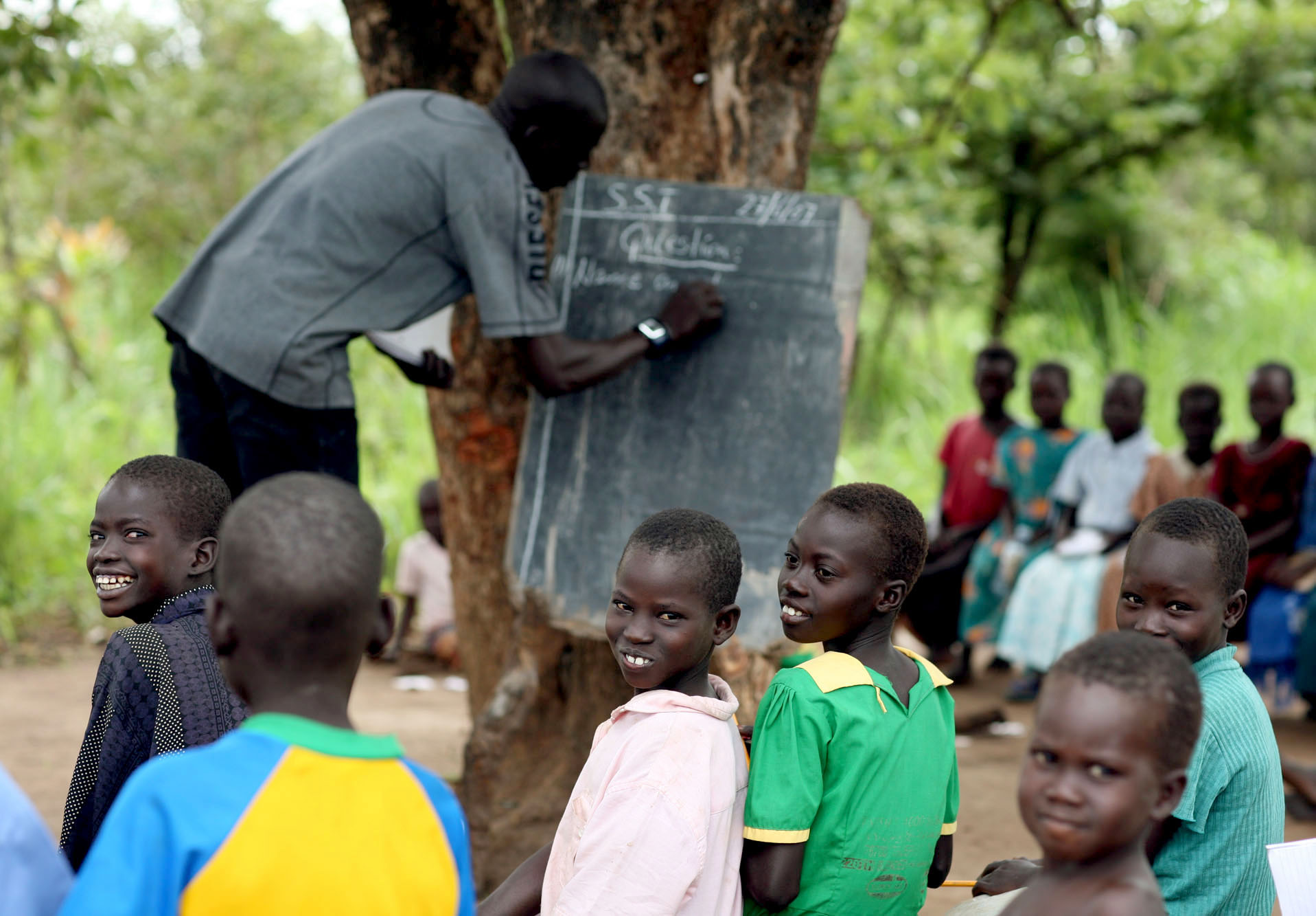 Children attend classes under a tree in a village near Yei, Southern ...