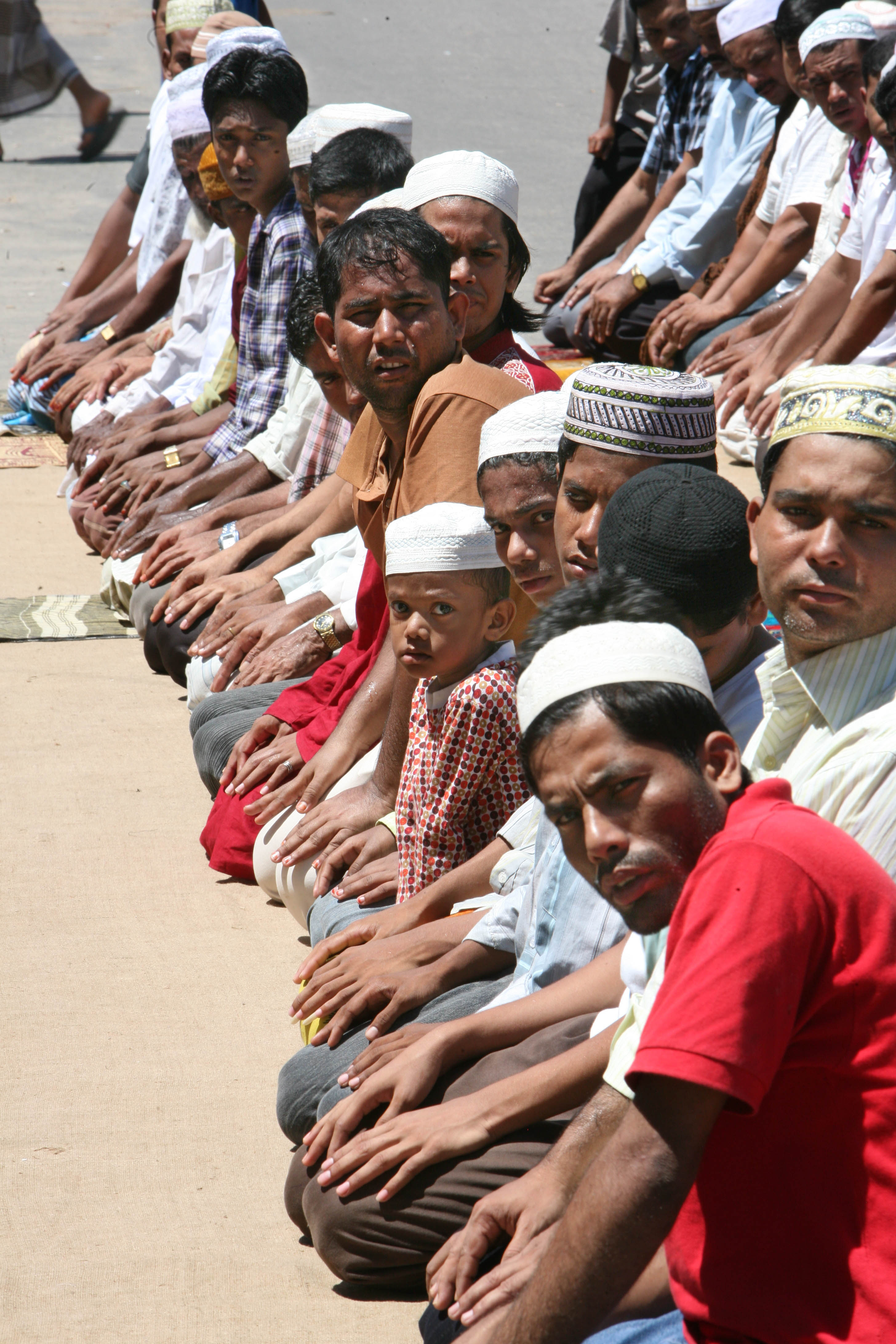 Muslims at prayer on a city street in the capital Dhaka, Bangladesh ...