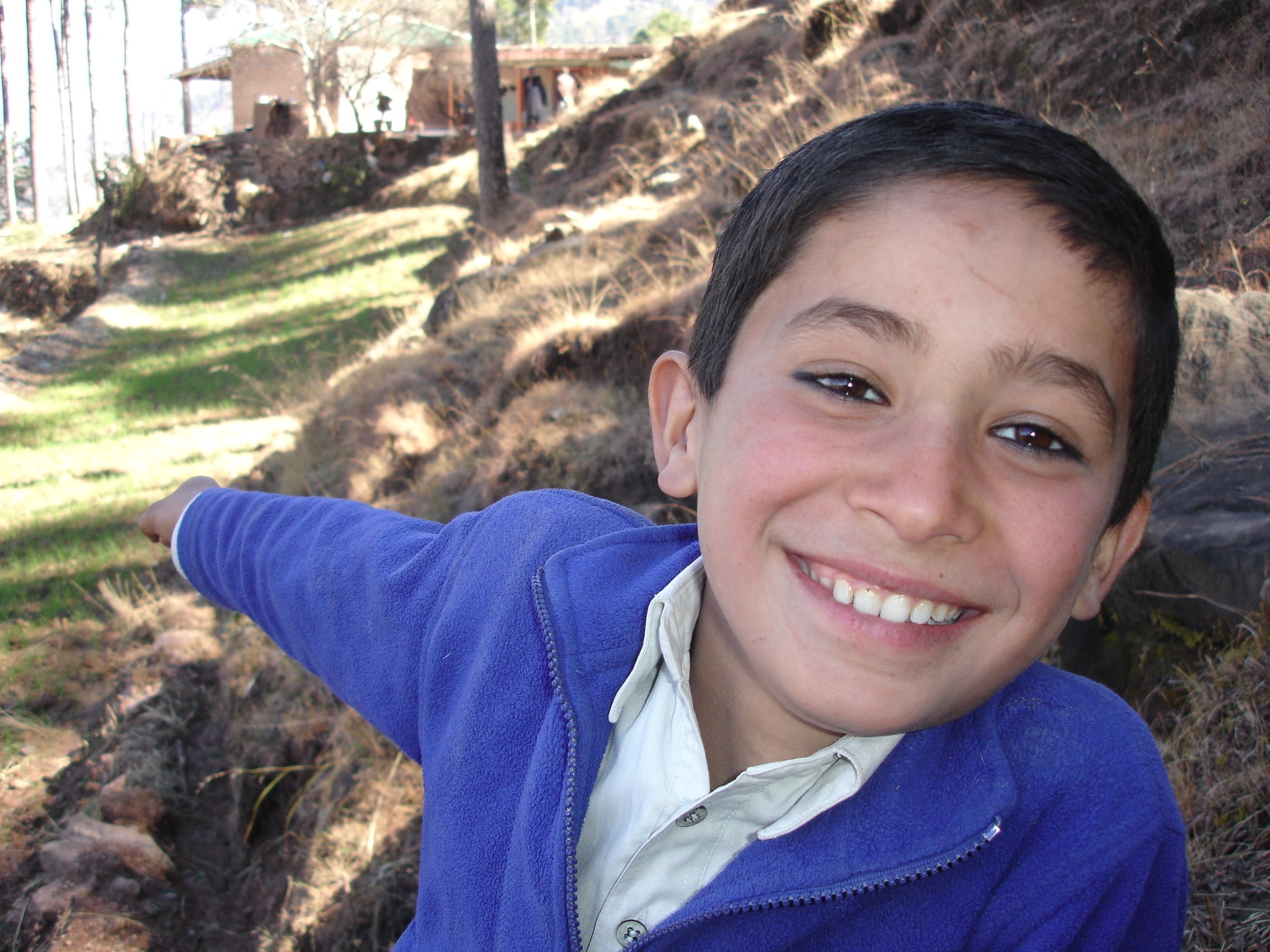 Nine-year-old Mohammad Ahmad Nafees smiles to the camera while pointing ...