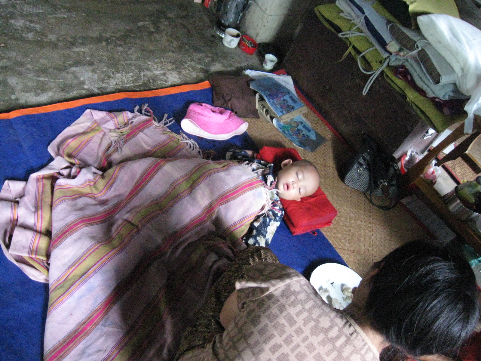 A young girl lies sick with dengue fever at a monastary in Pyapon in ...