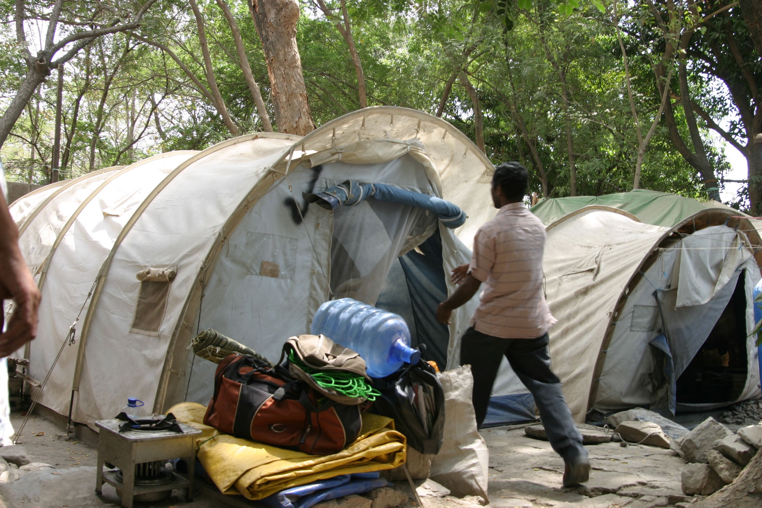 A displaced person in Balide camp in Dili, the capital, packs his ...