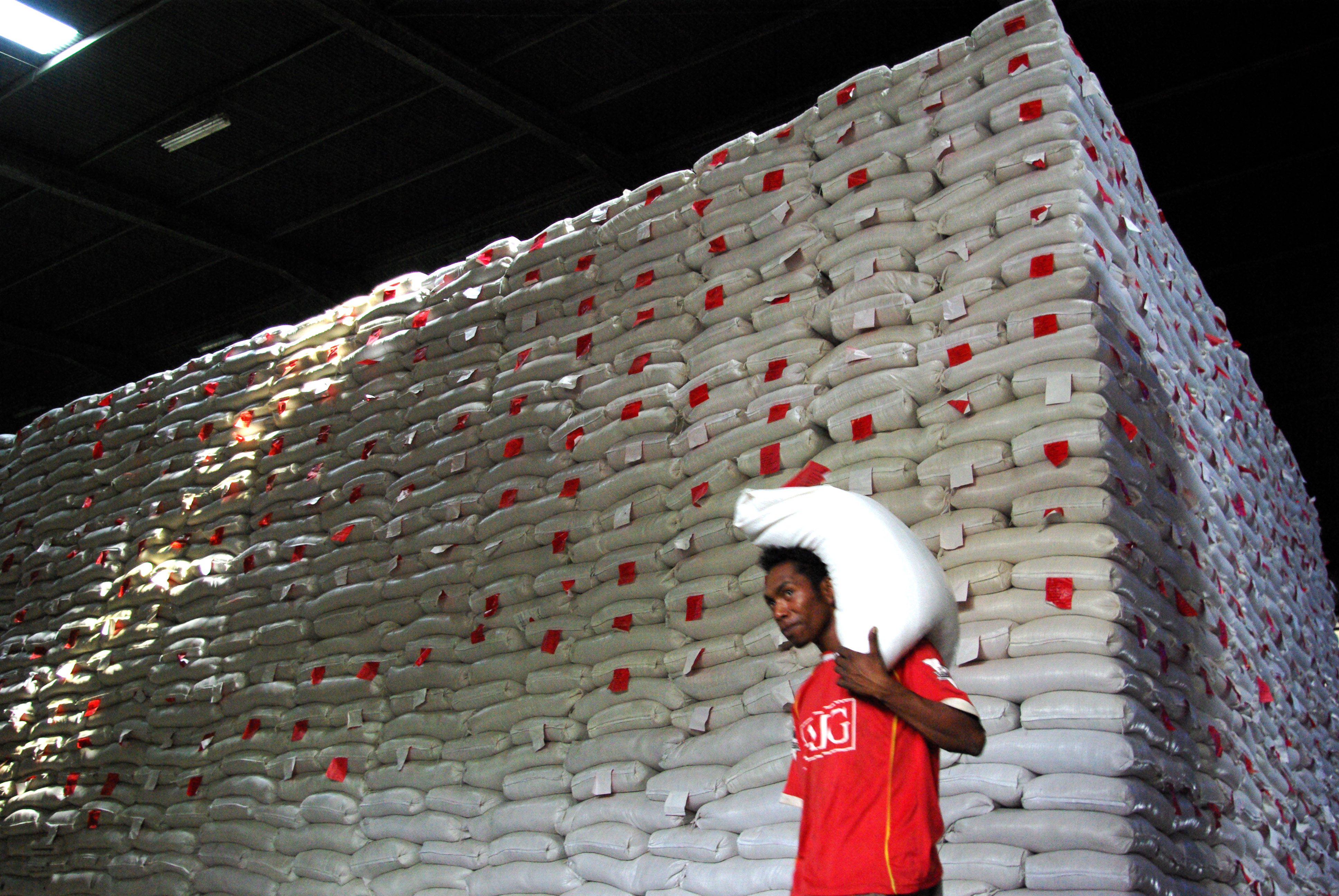 WFP rice is piled high in the Dili food warehouse. This was the first ...