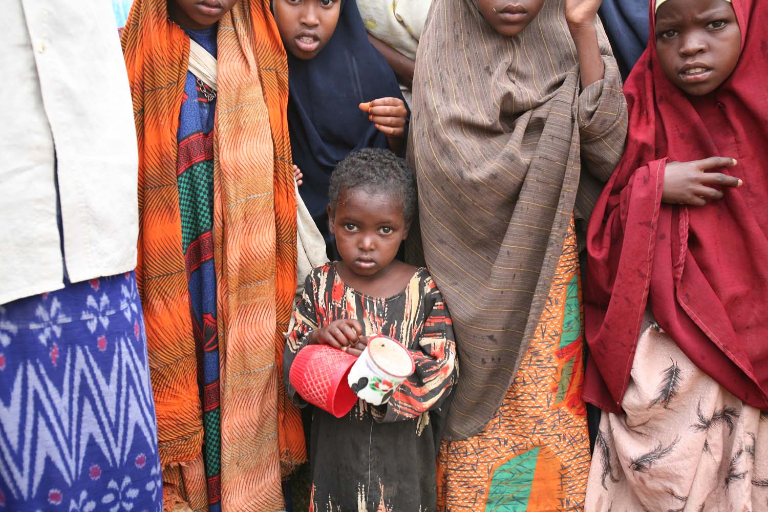 Somali children look on as they wait for their turn to be registered by ...