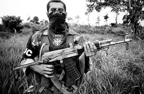 An AUC paramilitary fighter armed with a Kalashnikov assault weapon in ...