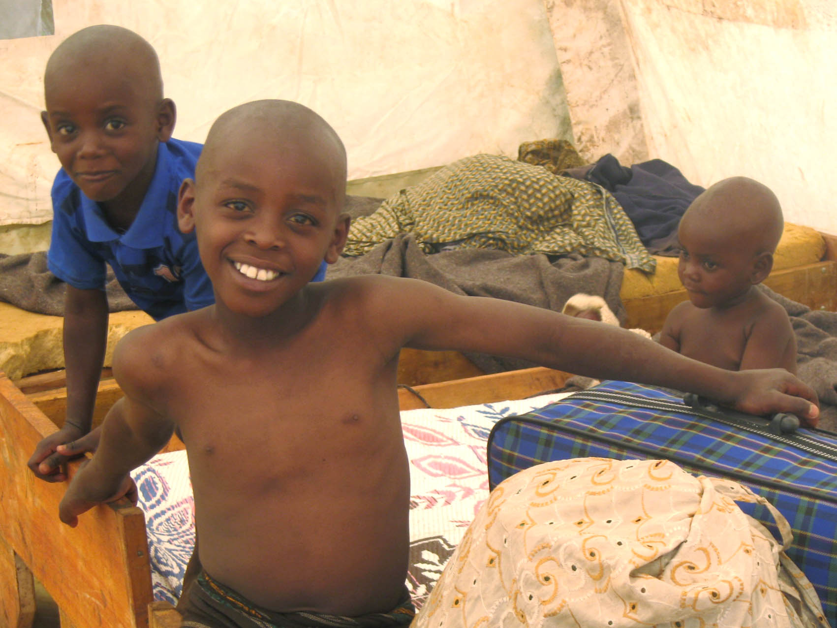 A group of Rwandan children inside a tent at a UNHCR transit site in ...