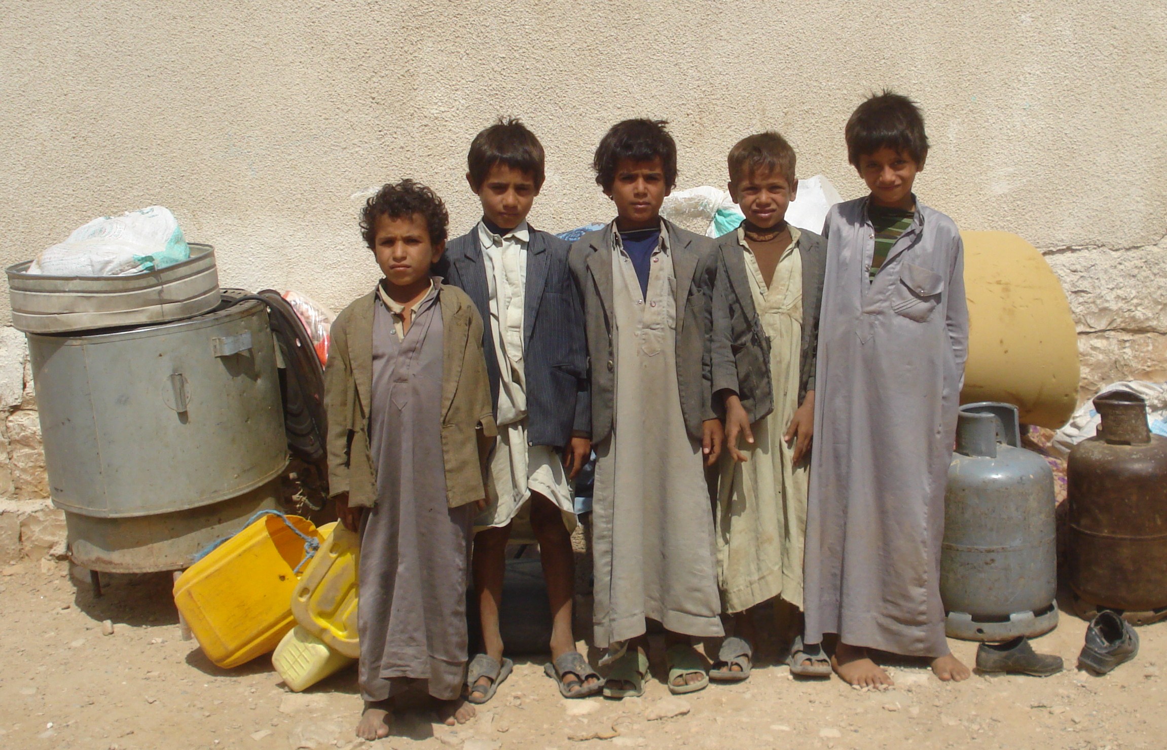 Displaced children with their cooking items at a rural school in Amran ...
