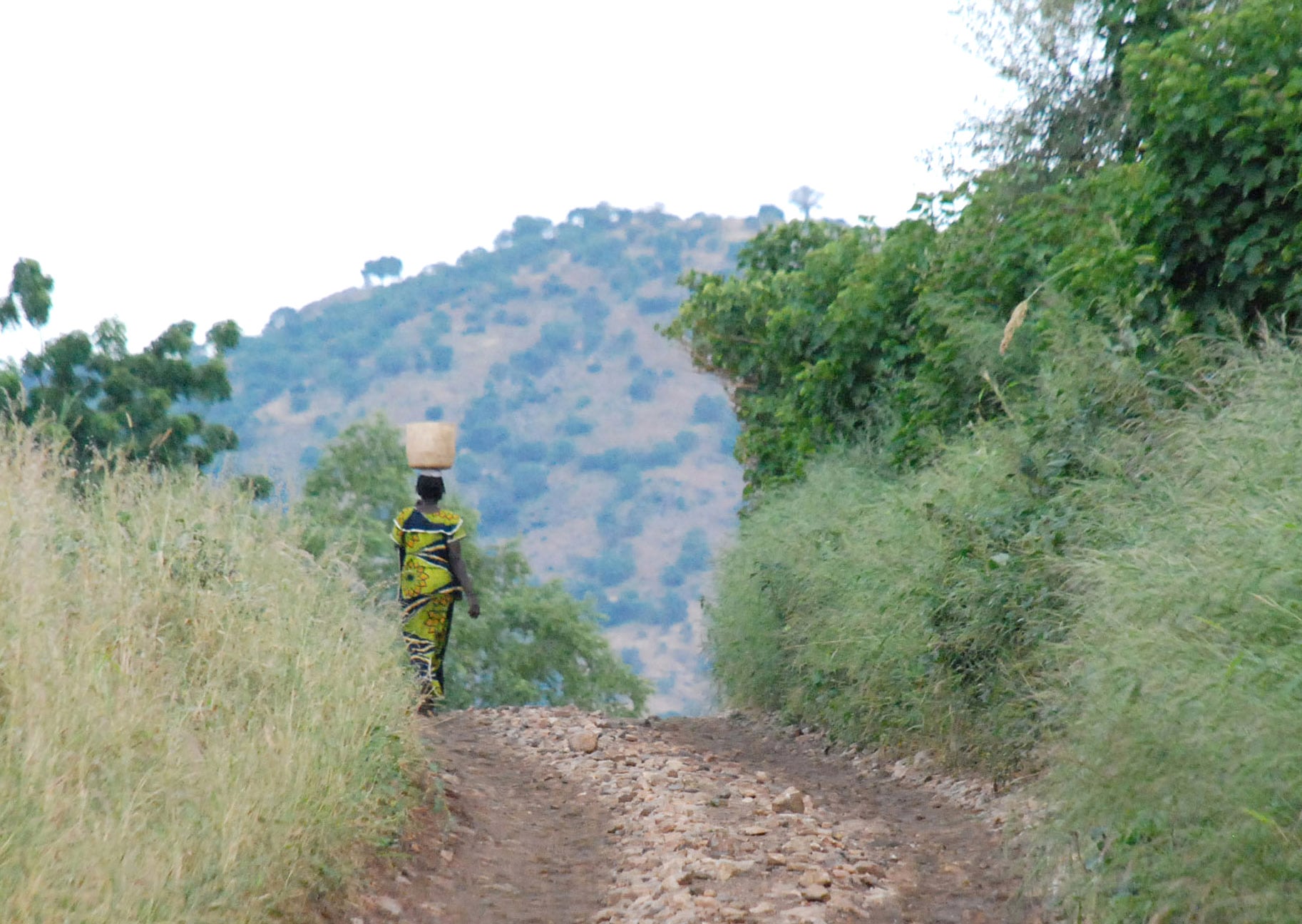 A Sudanese woman walks home from market at Kauda, in the Nuba Mountains ...