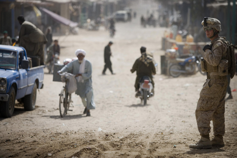 A US Marine patrols Lakari Bazaar that has been rehabilitated by US ...