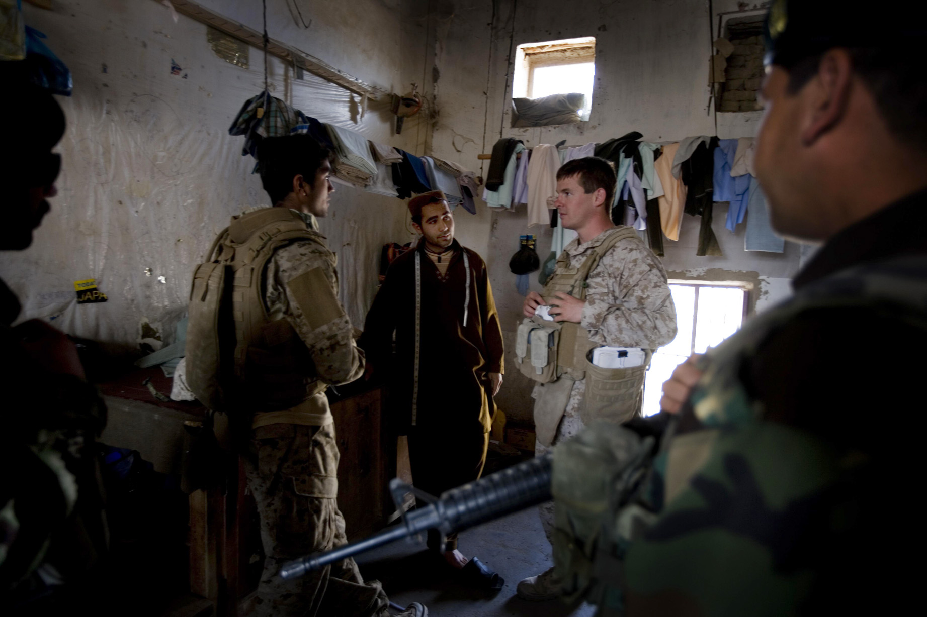 A US Marine talks to local store keepers while on foot patrol in Lakari ...