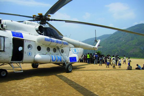 A helicopter arrives at the Mugunga camp in a remote part of eastern DR ...