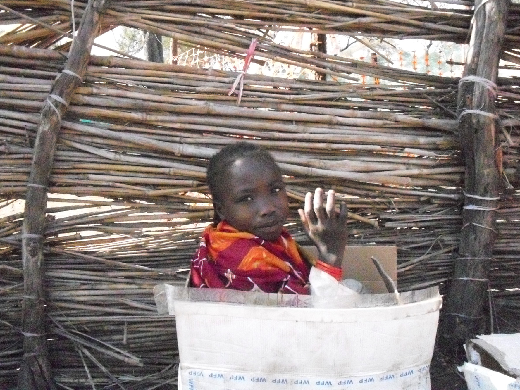 A girl plays in A WFP box | | The New Humanitarian