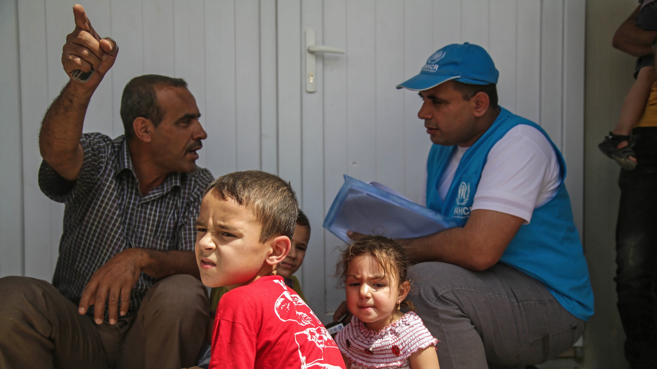 UNHCR staff meets with IDP’s from Mosul at the Khazair checkpoint, the ...